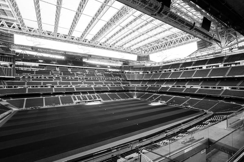 Black and white photograph of Santiago Bernabeu Stadium showing the retractable roof structure in Madrid
