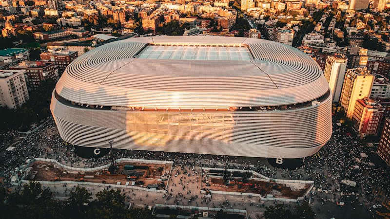 Aerial photograph of Santiago Bernabeu Stadium and surrounding Madrid cityscape during sunset