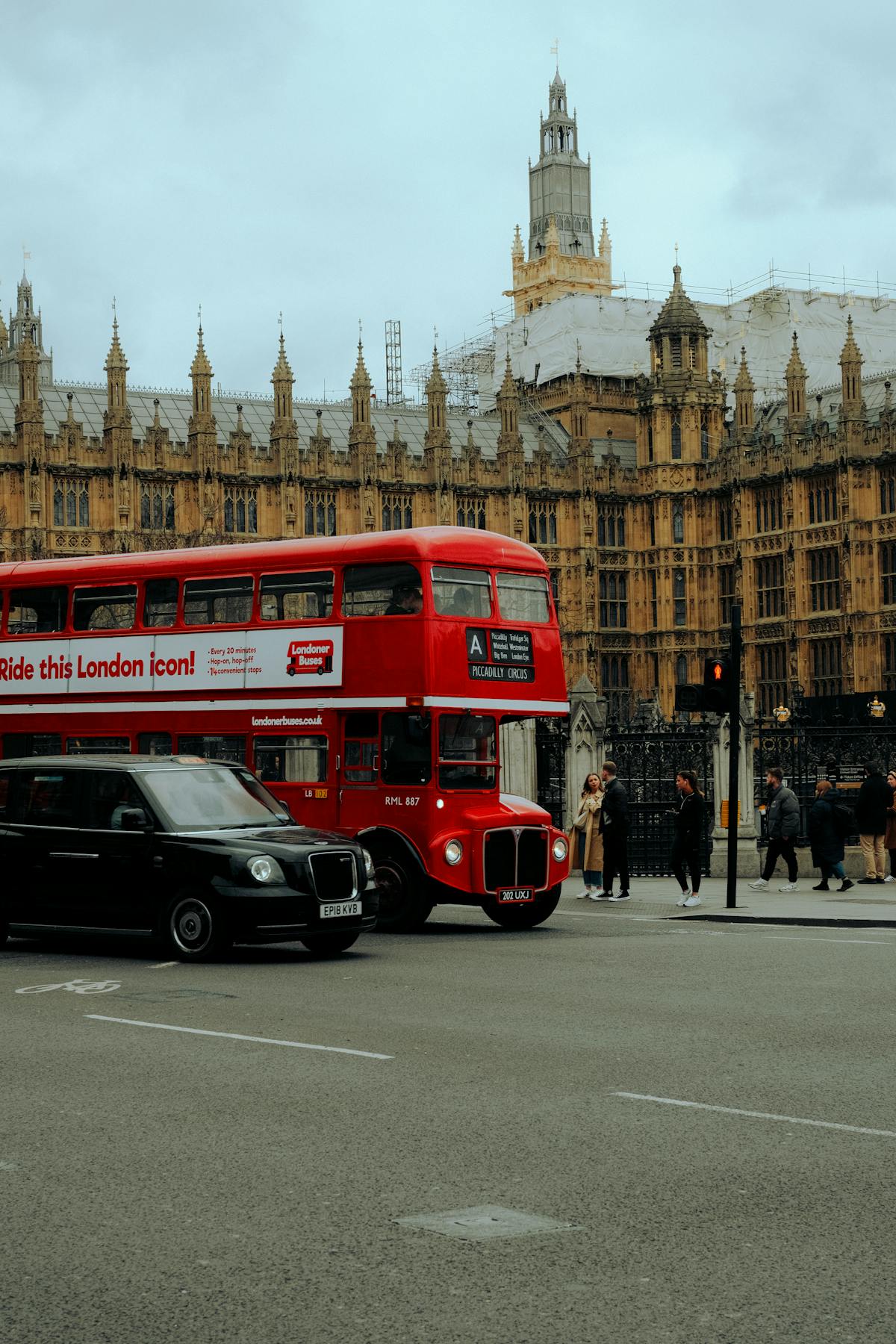 Close view of Big Ben with a red London bus