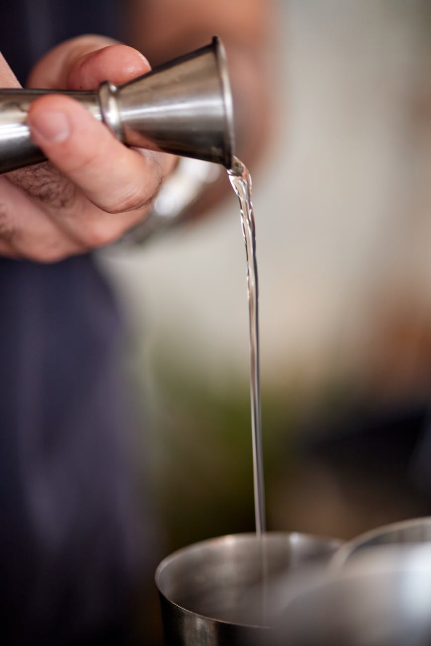 Bartender pouring drinks at a lively pintxos bar in Bilbao's old town