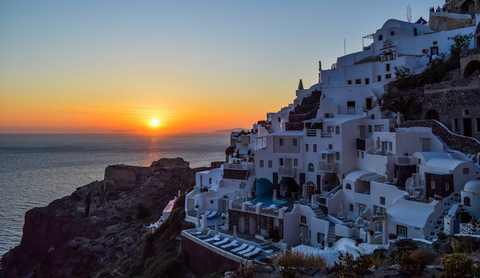 Santorini white village and blue domes at sunset