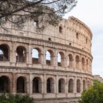 The Colosseum in Rome on a clear day showcasing its iconic arched facade
