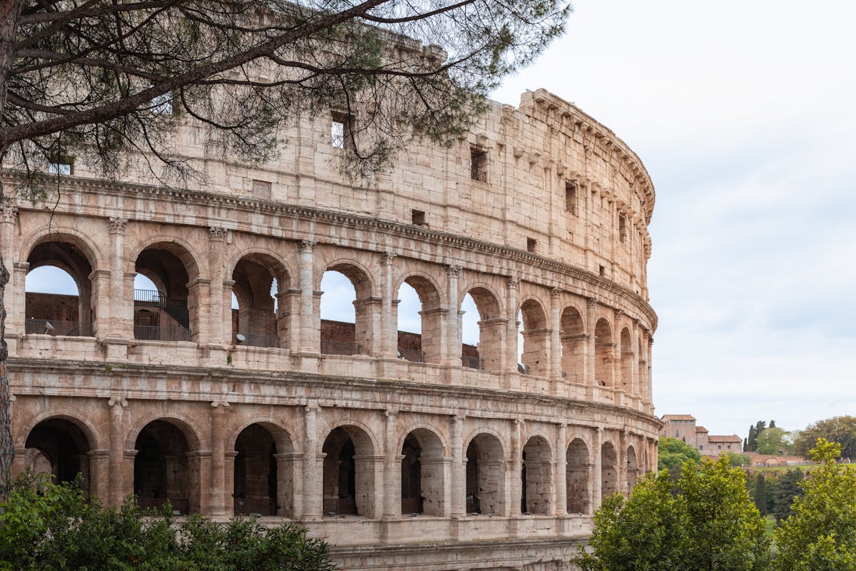 The Colosseum in Rome on a clear day showcasing its iconic arched facade