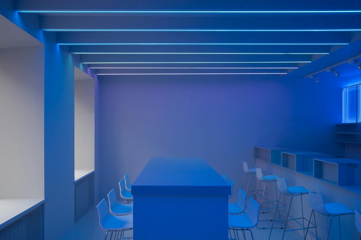 Modern minimalist bar interior with blue-toned lighting