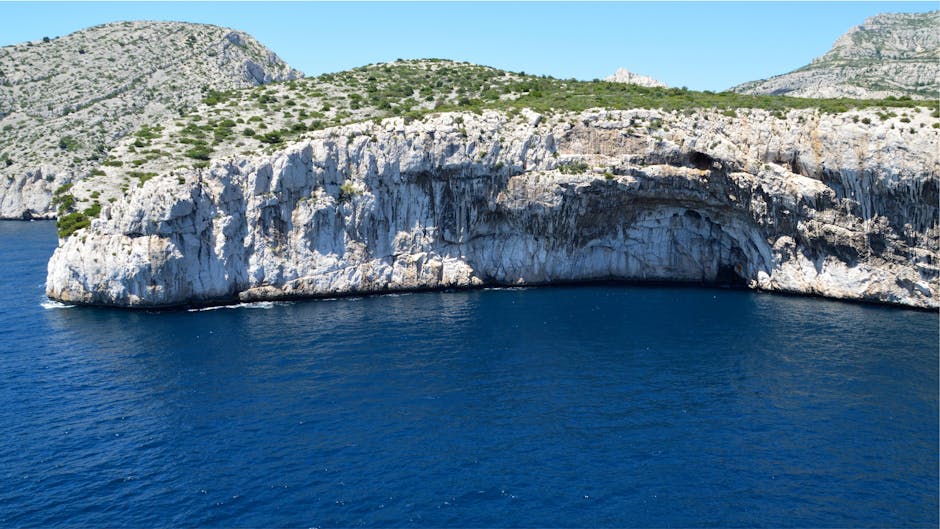 Majestic cliffs with rugged texture and green vegetation on Vis