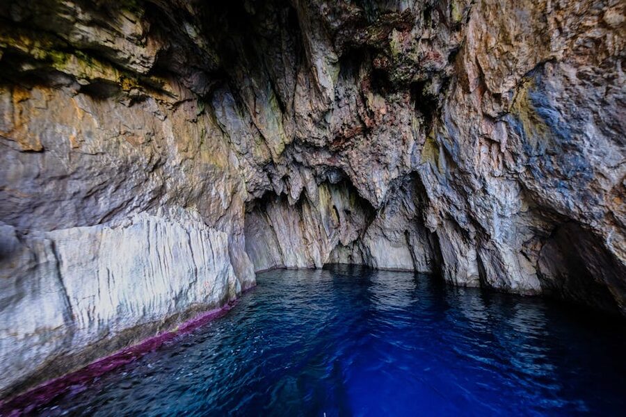 Natural sea cave interior with refracted blue light