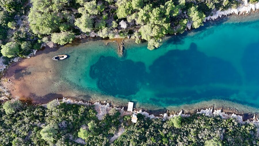 Aerial view of a turquoise lagoon surrounded by cliffs