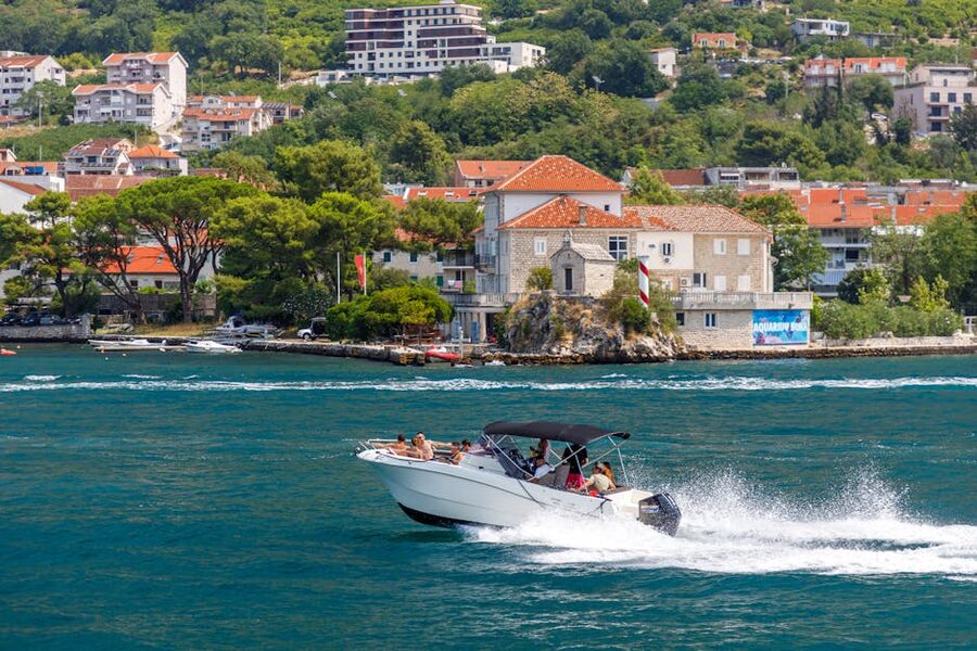 Speedboat racing along the scenic Adriatic coast on a sunny day