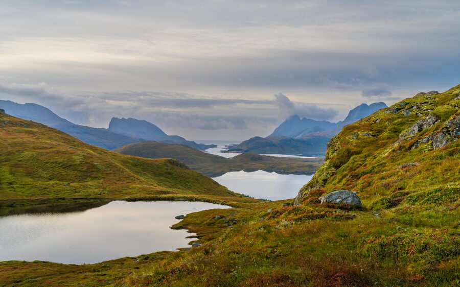 Tranquil mountain lake view in Lofoten Islands, Norway, during autumn.