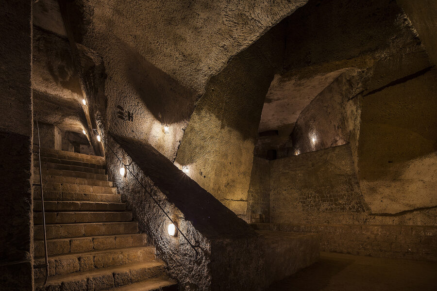 Ancient water cistern with stone steps inside the Bourbon Tunnel underground complex in Naples