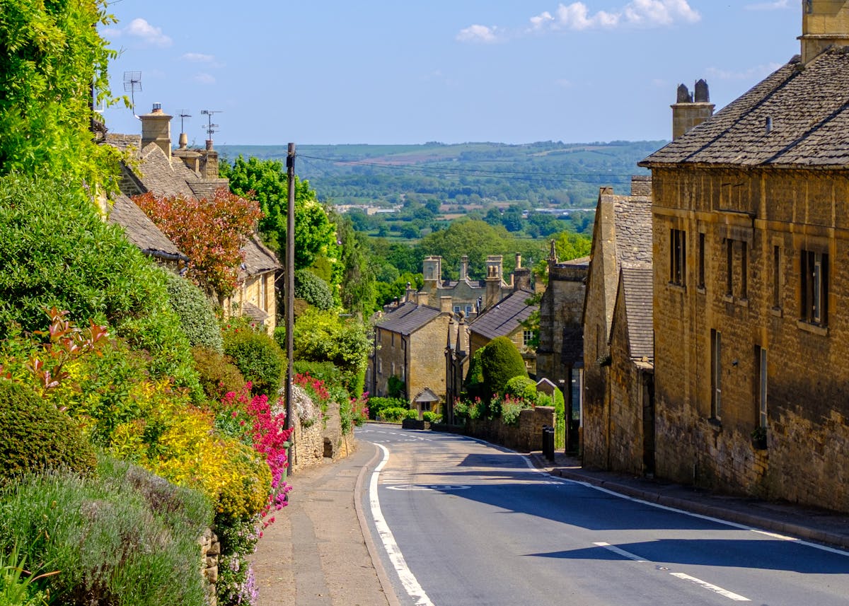 River Windrush flowing through Bourton-on-the-Water with low stone bridges and village buildings