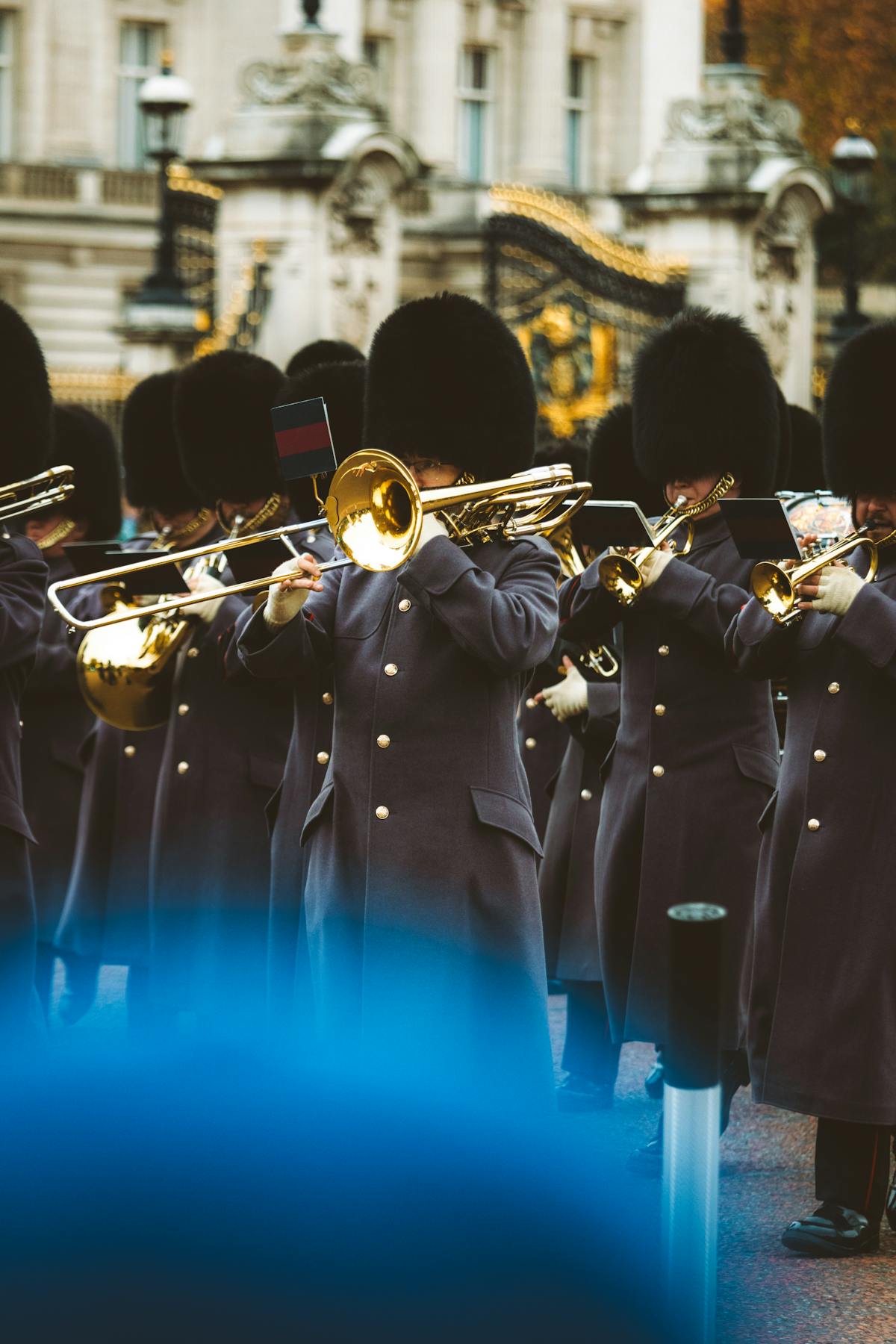 Traditional British guards in uniform playing brass instruments outside Buckingham Palace London