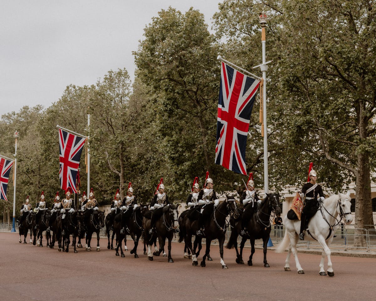 Ceremonial cavalry with Union Flags in a historical parade on The Mall London