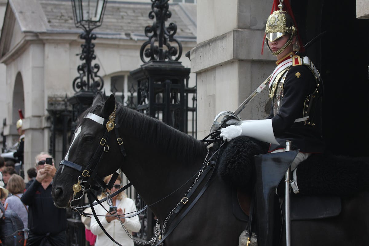 British Royal Guard in ceremonial uniform on horseback at a London landmark