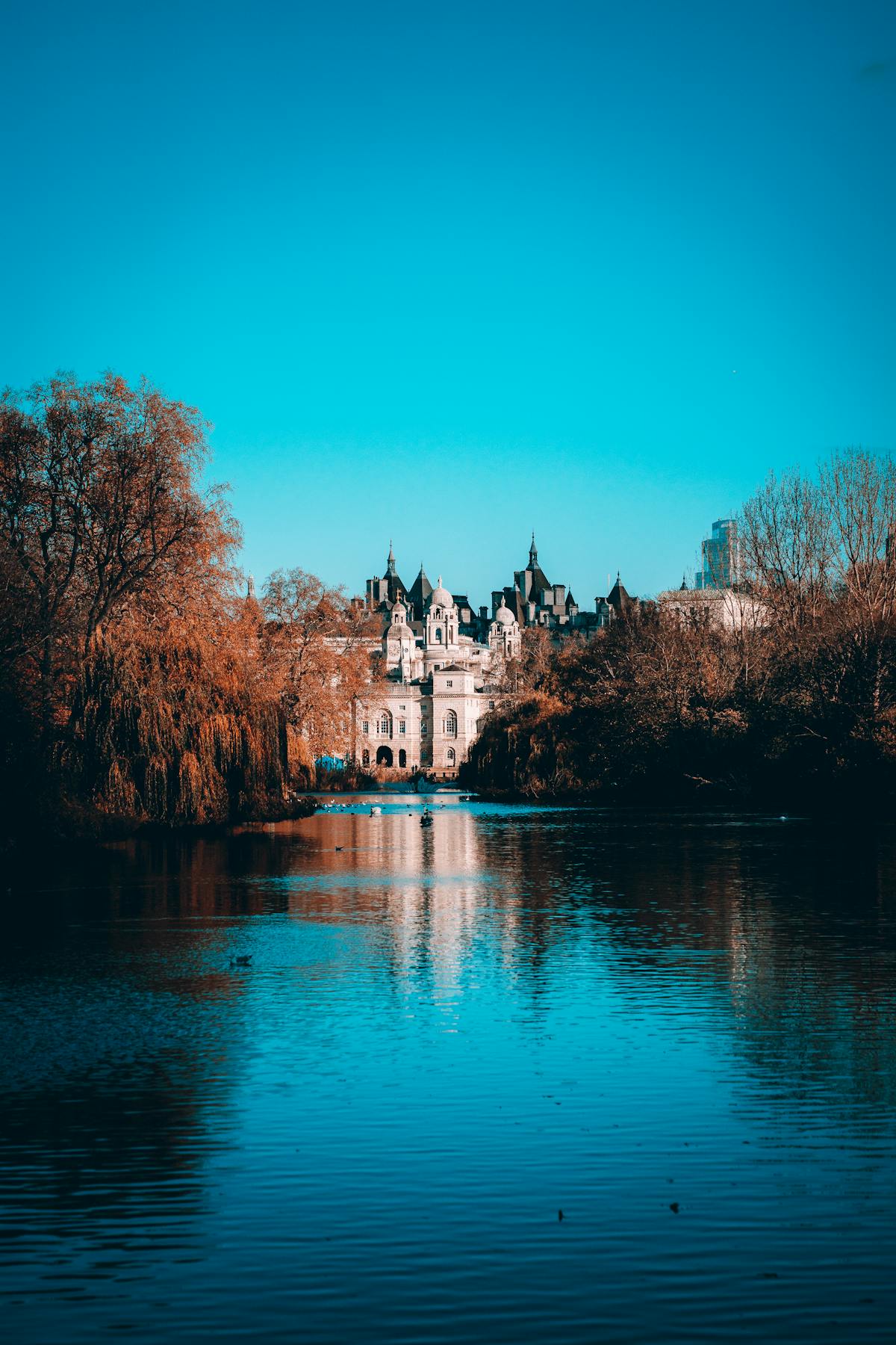 Scenic view of St James Park with lake reflections and historic architecture in London England