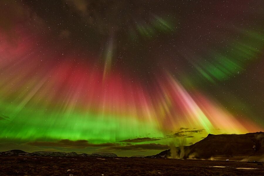 Breathtaking view of the Aurora Borealis in the night sky above ReykjahlÃ­Ã°, Iceland.