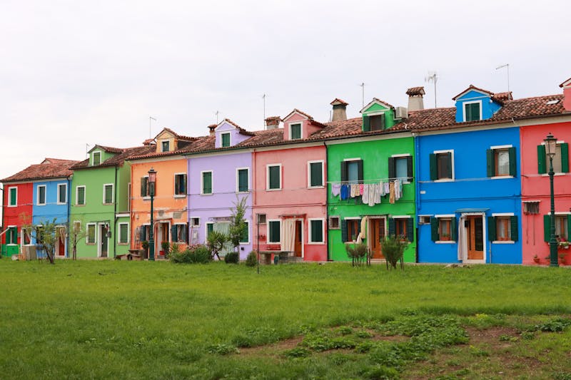 Colorful houses in Burano, Venice with laundry hanging on clotheslines between buildings