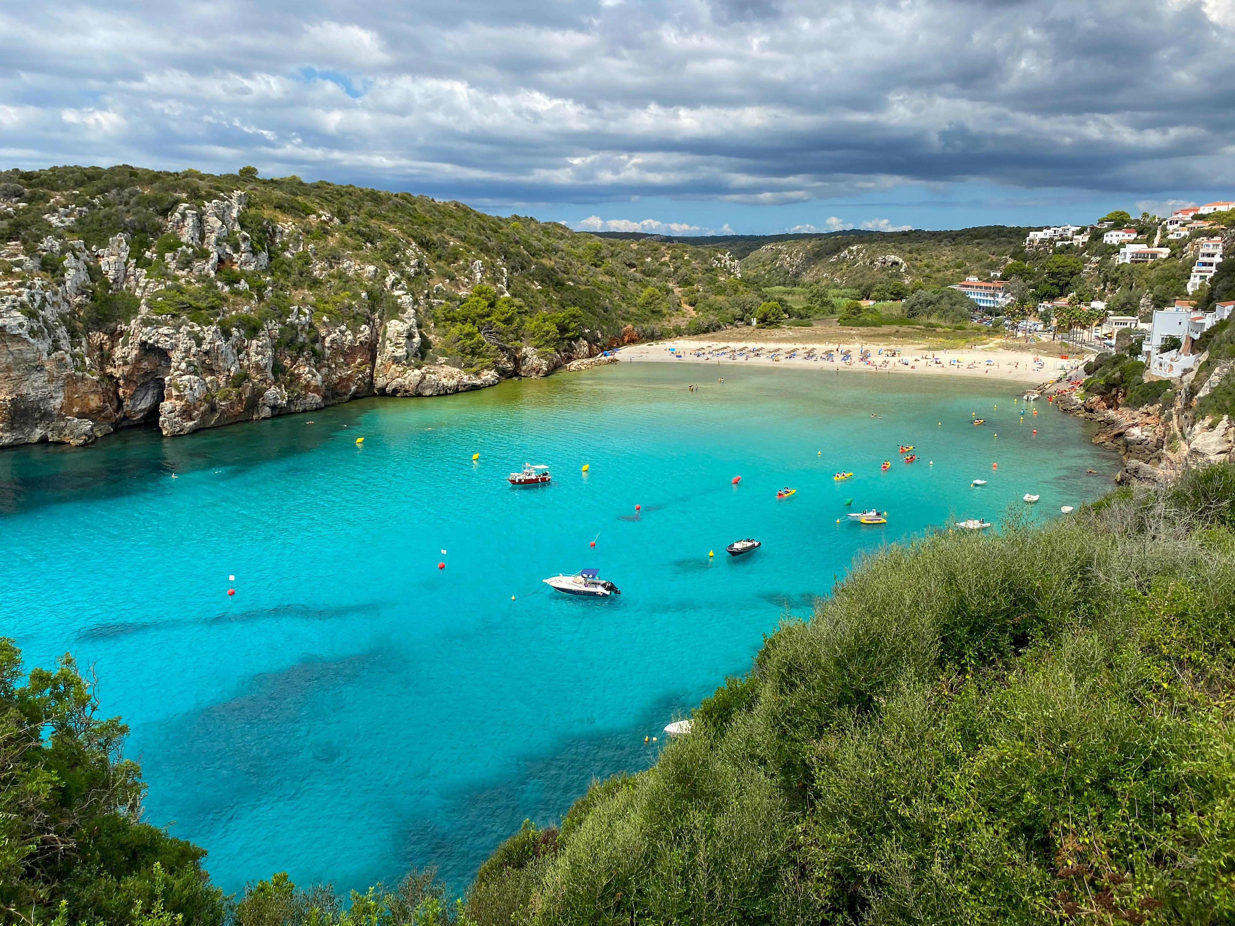 Aerial view of Cala en Porter beach in Menorca with turquoise sea