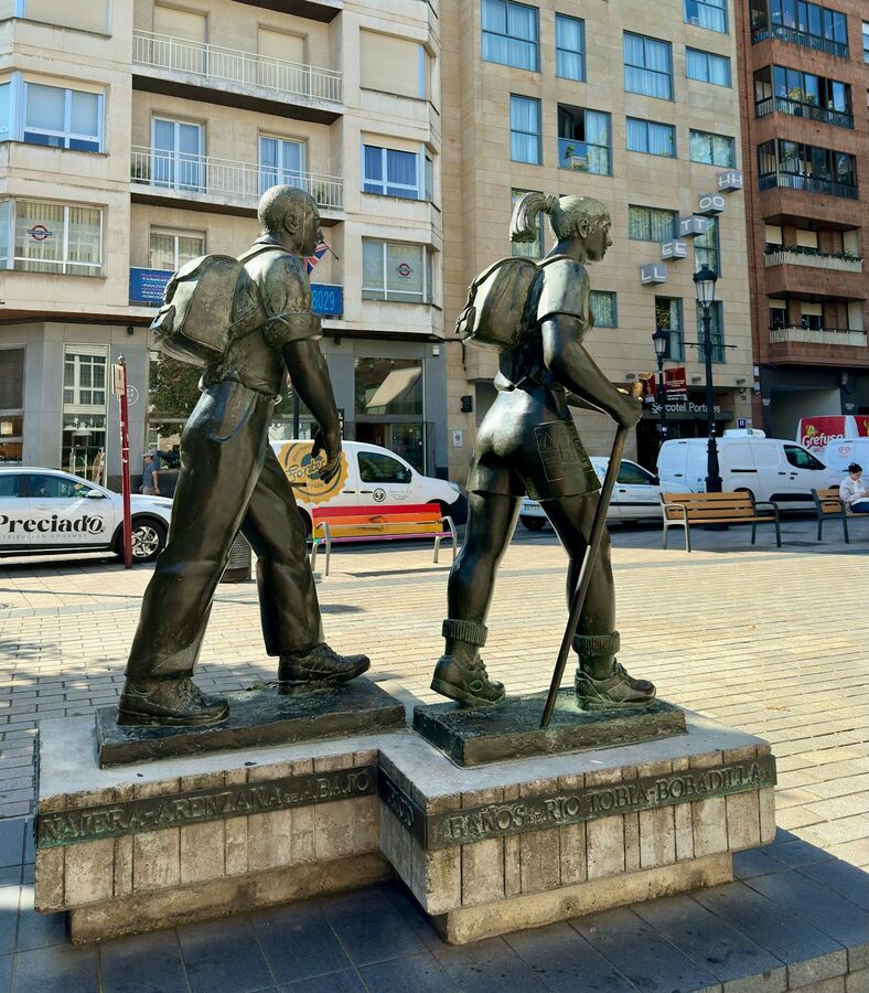 Bronze statues of pilgrims on the Camino de Santiago route in Spain