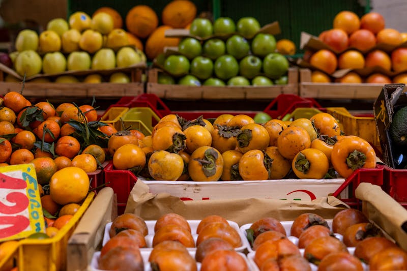 Fresh persimmons and tangerines at a market in Rome Italy