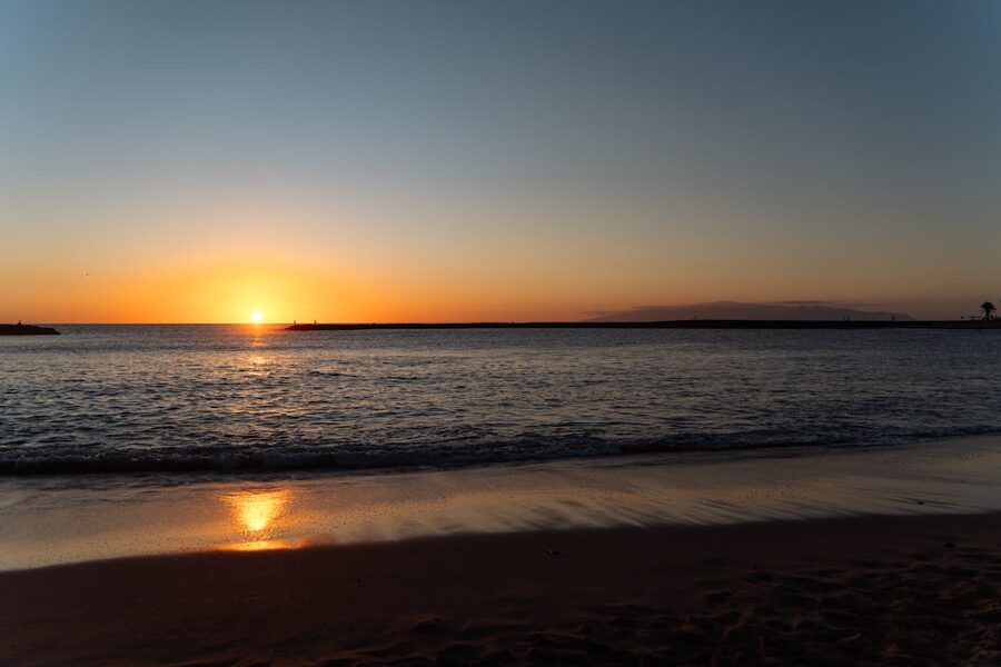 Beautiful sunset over a Canary Islands beach with golden sky