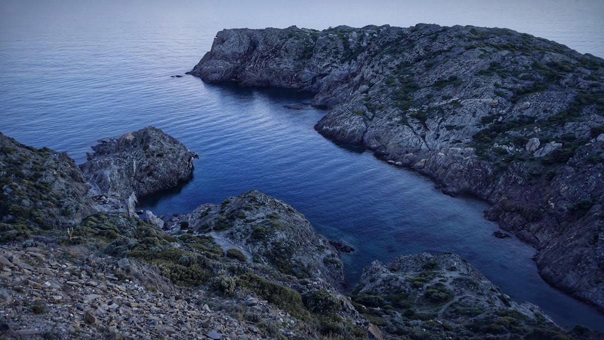 Dramatic rocky coastline meeting azure sea at Cape Creus on the Costa Brava Spain