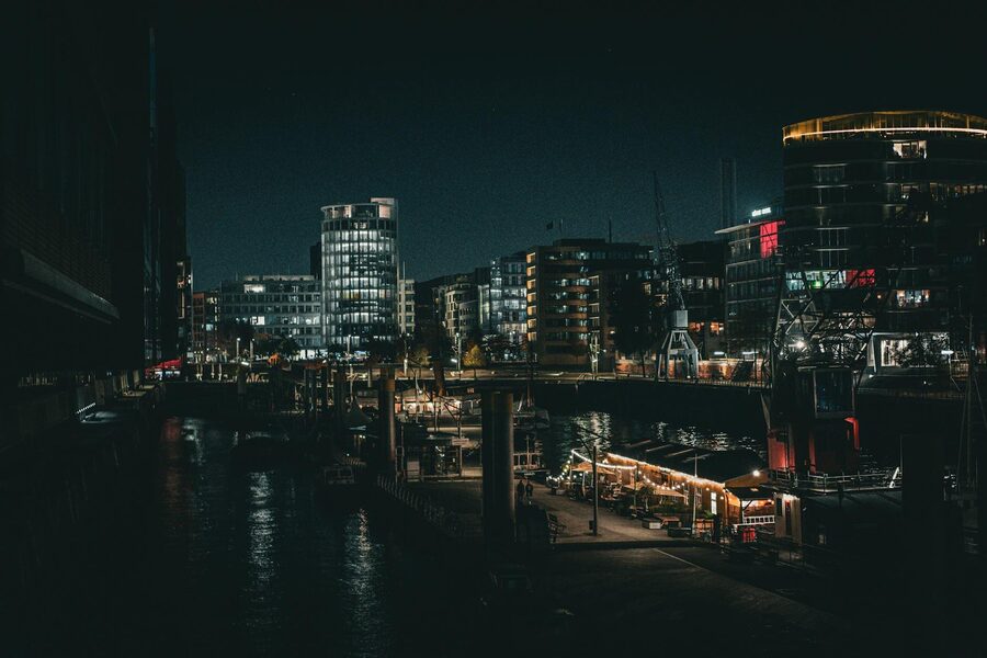 Night view of Hamburg port with city lights reflecting on water