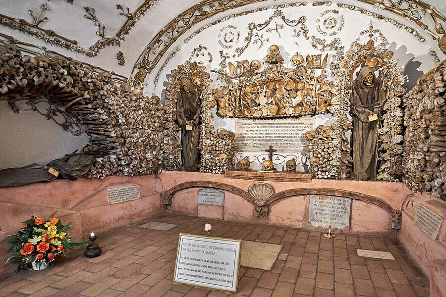 Interior view of a Capuchin ossuary chapel in Rome with bone decorations lining walls and ceiling