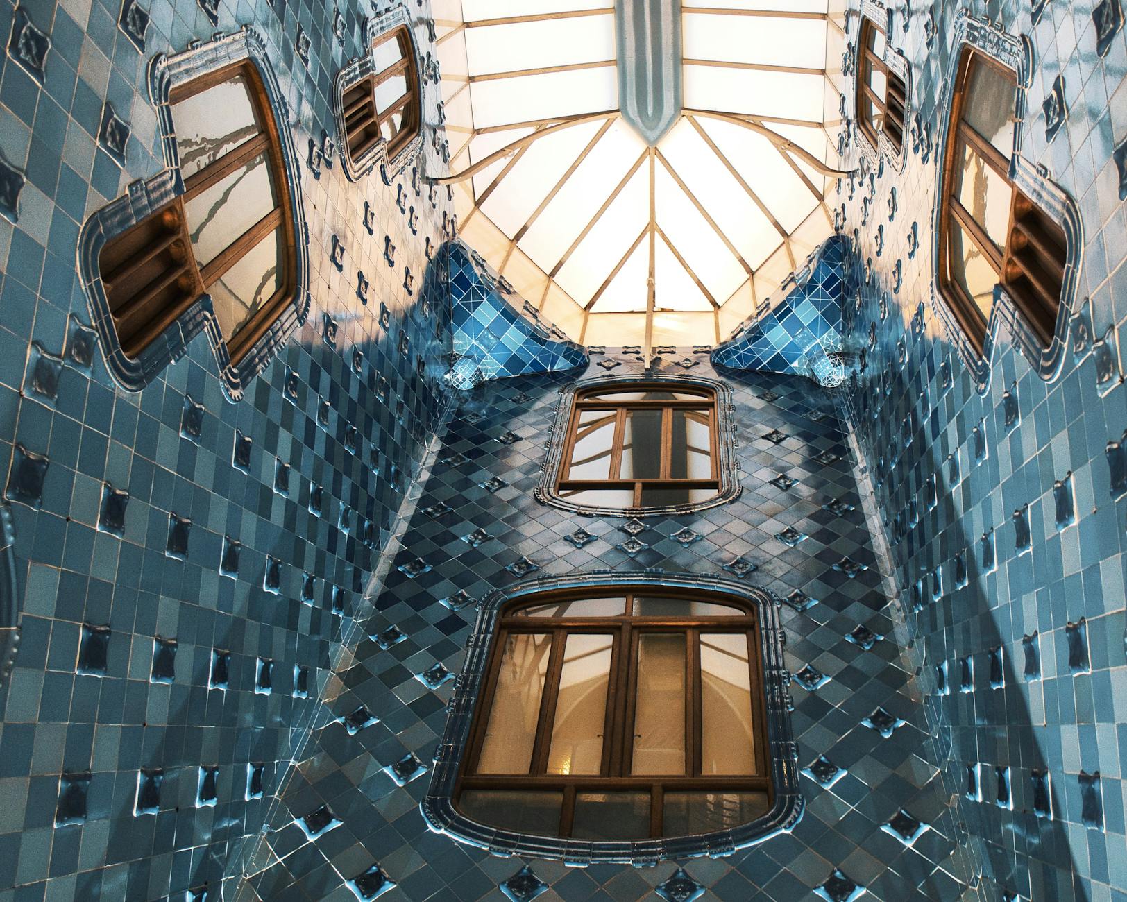 Blue-tiled interior and skylight of Casa Batllo in Barcelona