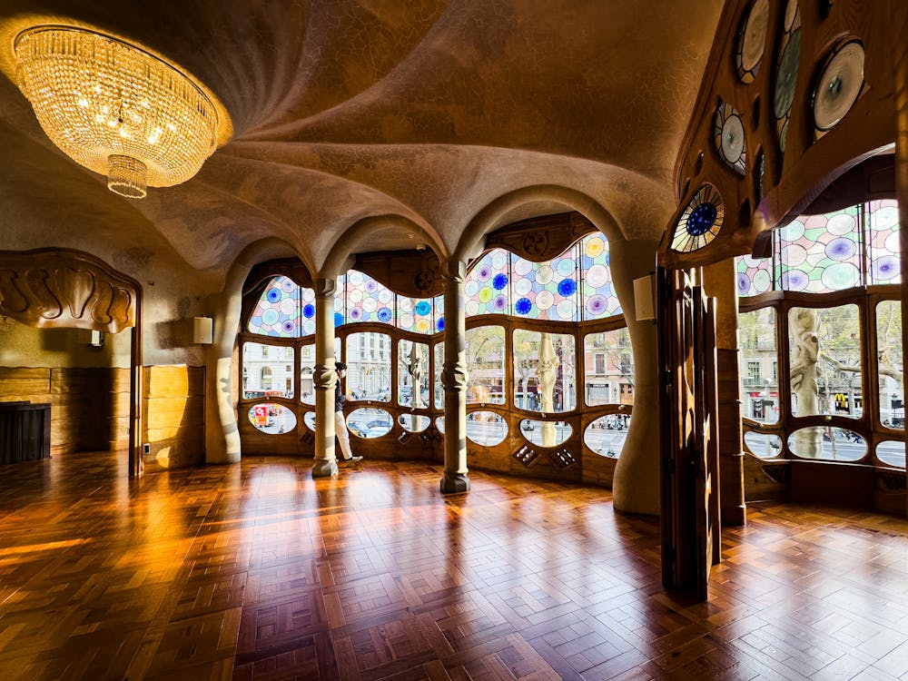 Interior of Casa Batllo showing Gaudi stained glass and organic design elements