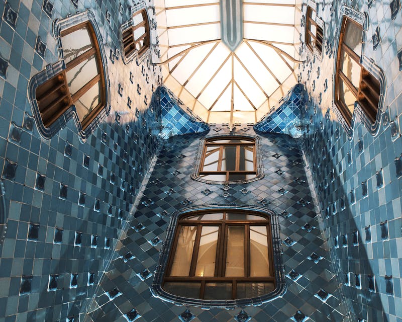 Blue-tiled interior lightwell of Casa Batllo showing Gaudi's innovative ventilation design