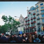 Crowd of visitors in front of Casa Batllo colorful facade on Passeig de Gracia Barcelona