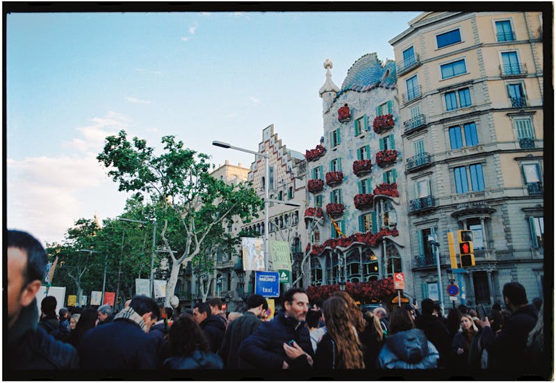 Crowd of visitors in front of Casa Batllo colorful facade on Passeig de Gracia Barcelona