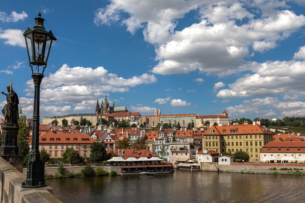 Prague Castle and the Vltava River as seen from Charles Bridge with statues