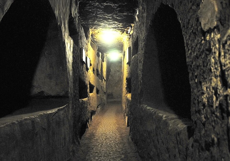 Underground corridor inside the Catacombs of Domitilla showing ancient walls and burial niches