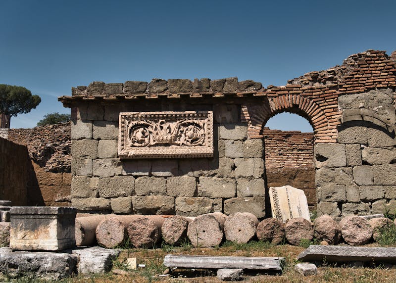 Historic ruins of ancient Rome with stone arches and carved details