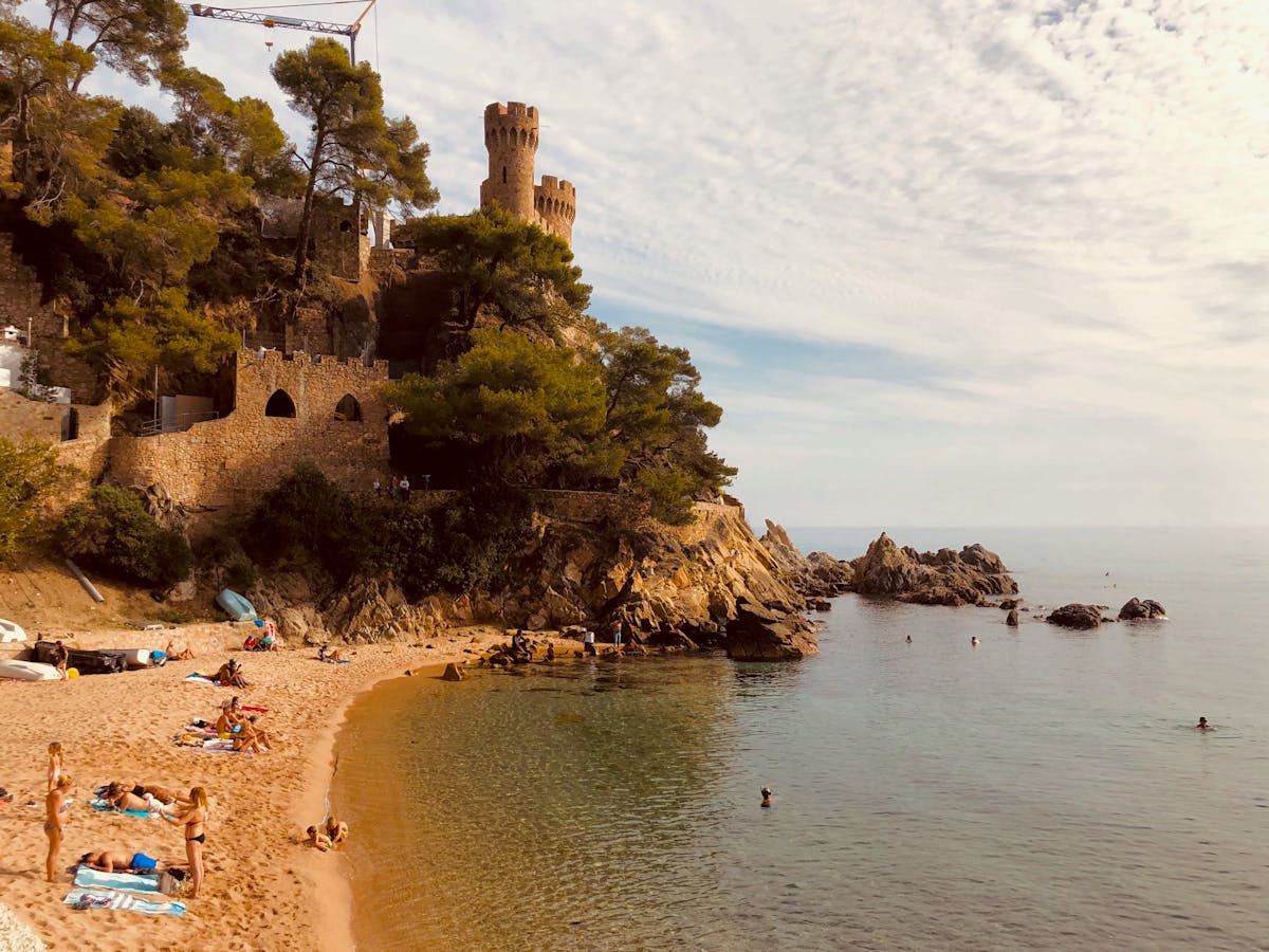 Scenic view of a medieval castle by the beach in Catalonia Spain