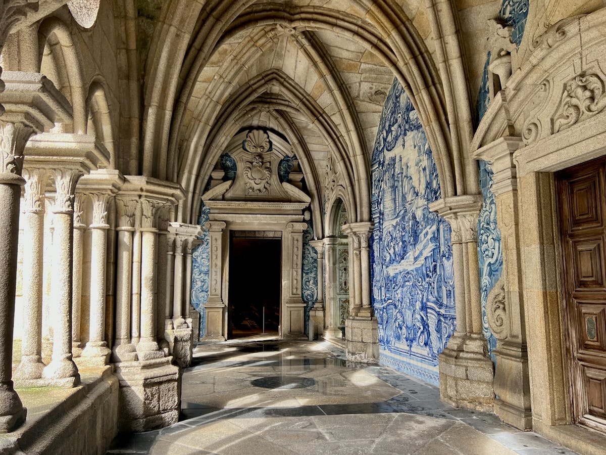 Gothic cloisters of Porto Cathedral with intricate blue azulejo tile decorations on the walls