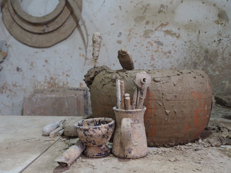 Artisan pottery tools and clay creations in a rustic workshop in Seville Spain