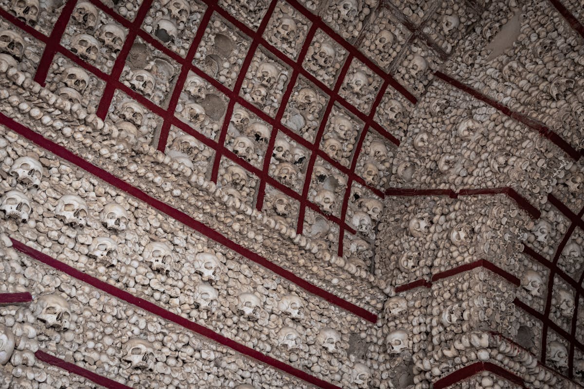 Interior of a chapel displaying bones and a cross in an ossuary