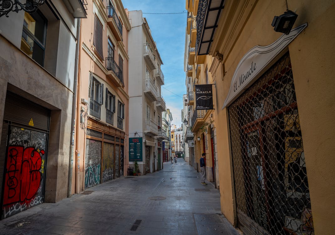 A narrow alleyway with historic buildings in Valencia old town
