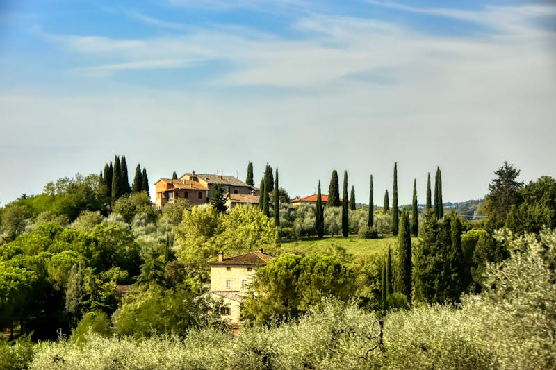 Traditional Tuscan villas nestled among lush green countryside hills