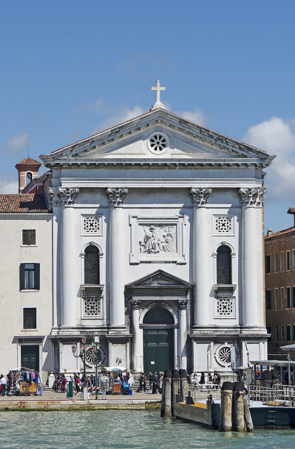 White neoclassical facade of the Chiesa della Pietà along the Venice waterfront