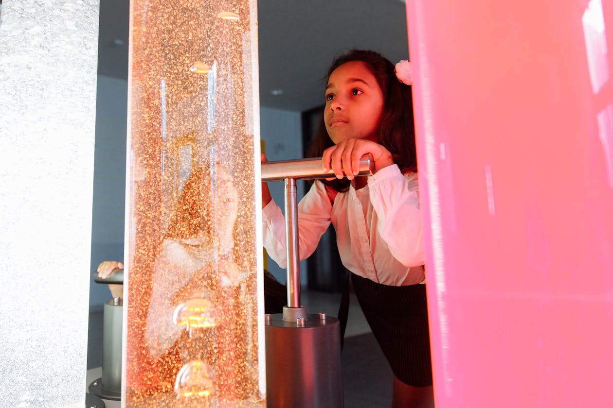 A child exploring a colourful interactive exhibit in a science museum