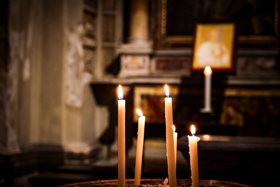 Warm candlelight creating a peaceful glow inside a church