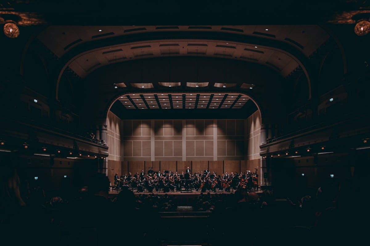 Orchestra performing a symphony in a grand concert hall