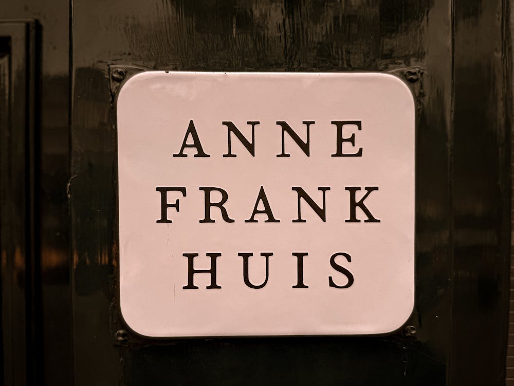 Close-up of the Anne Frank Huis sign on the building facade in Amsterdam