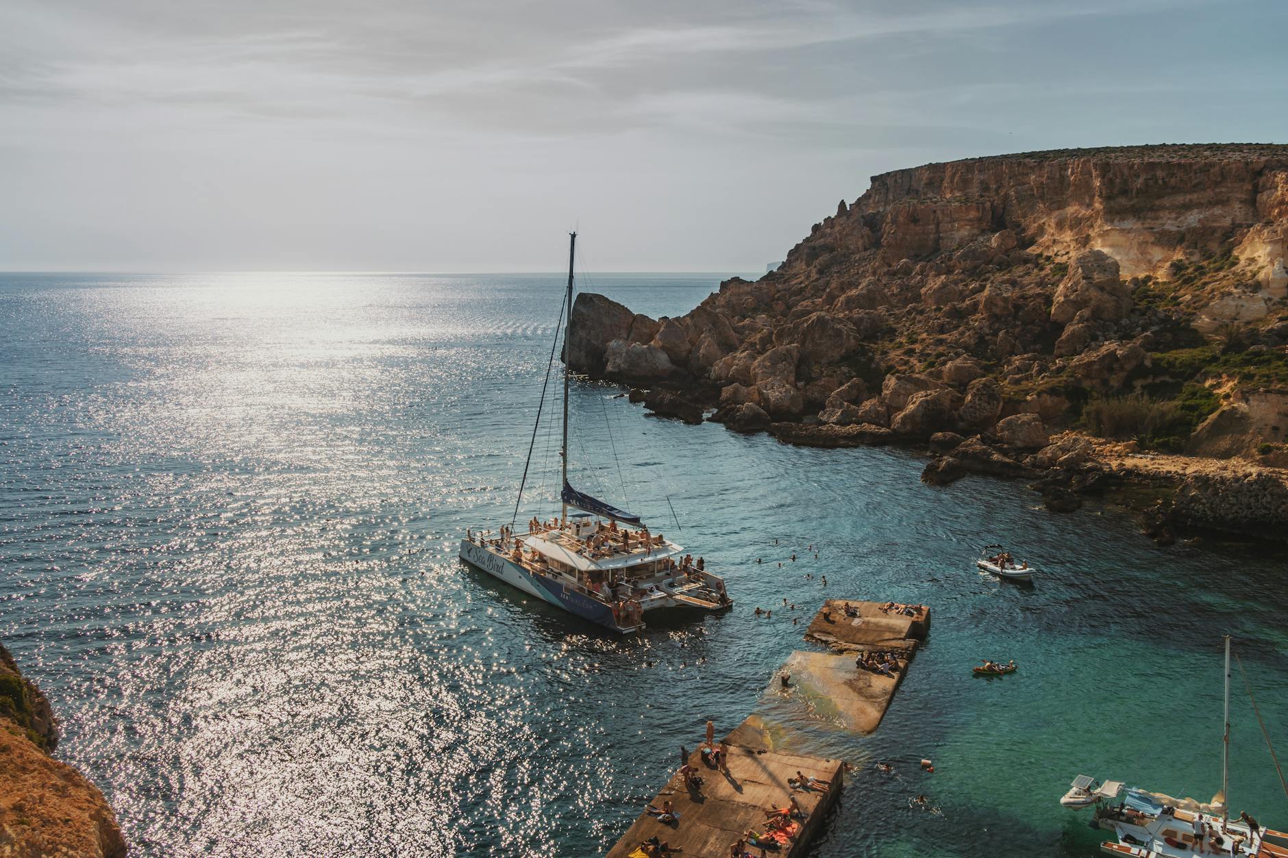 Yachts and swimmers in a sunny Mediterranean bay