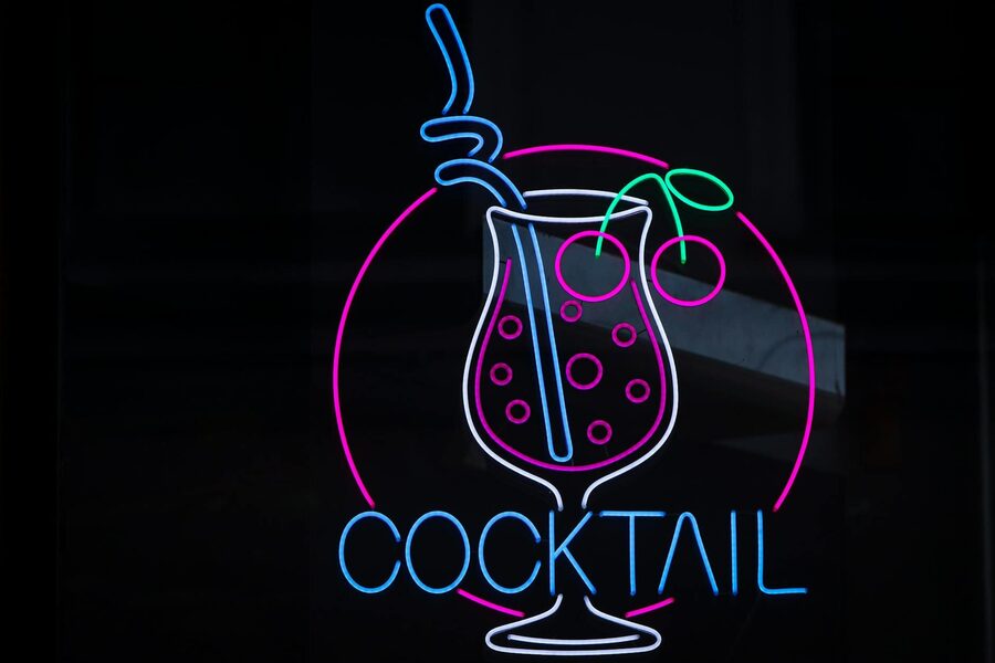Colorful neon cocktail sign glowing on a dark background