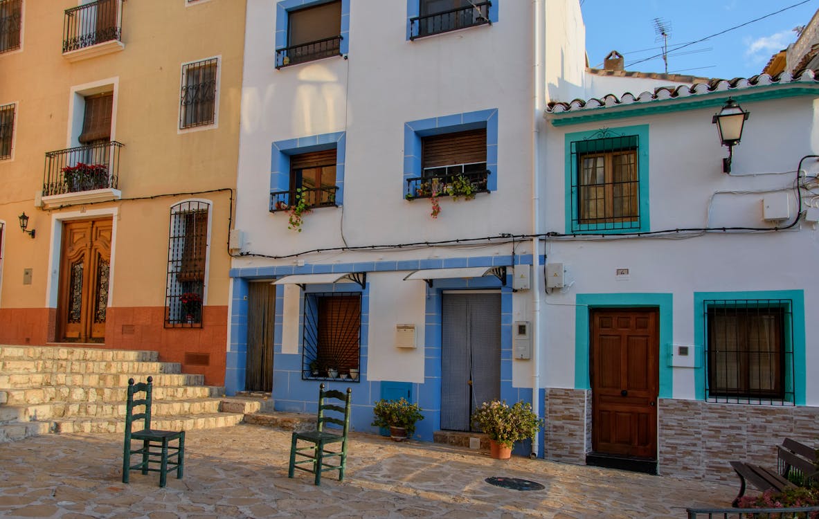 Colorful house facades in a sunny Spanish village street